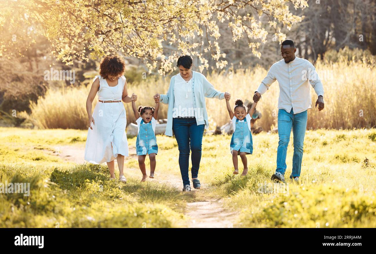 Walking, holding hands and family generations in nature at an outdoor ...