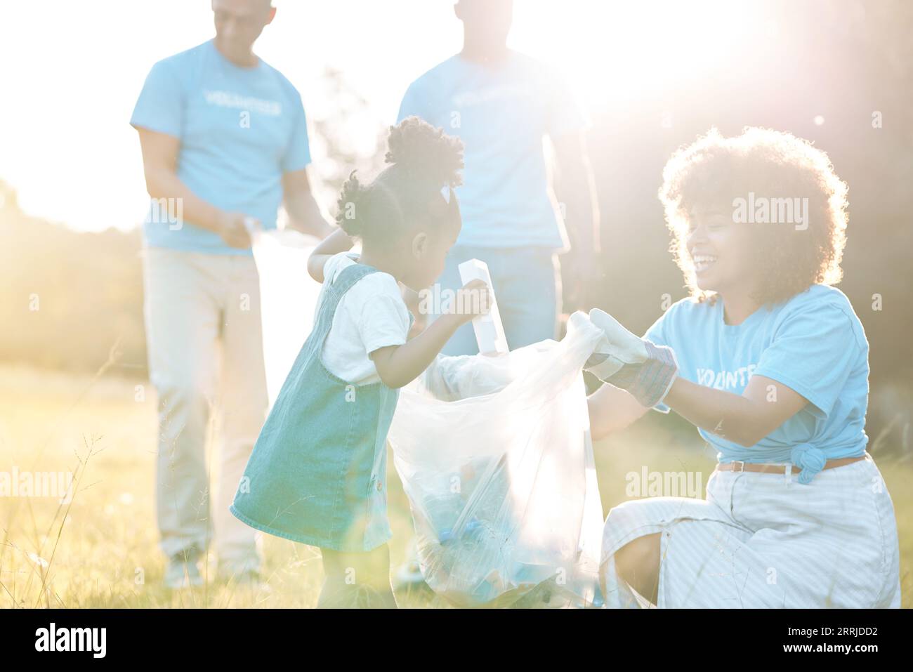 Nature activist, volunteering family and child cleaning garbage ...