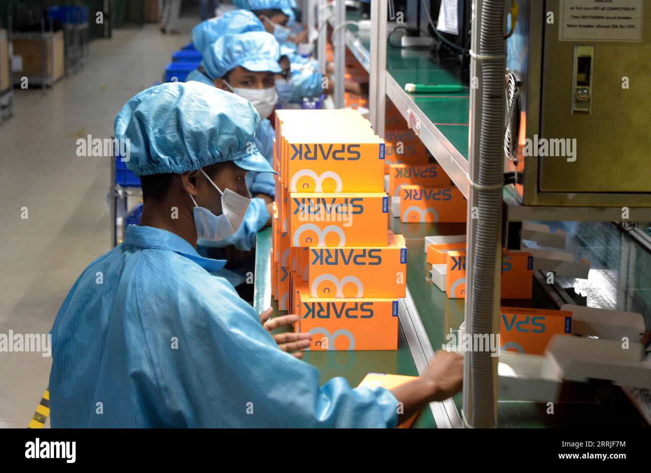 220721 -- GAZIPUR, July 21, 2022 -- Workers pack cellphones on an ...