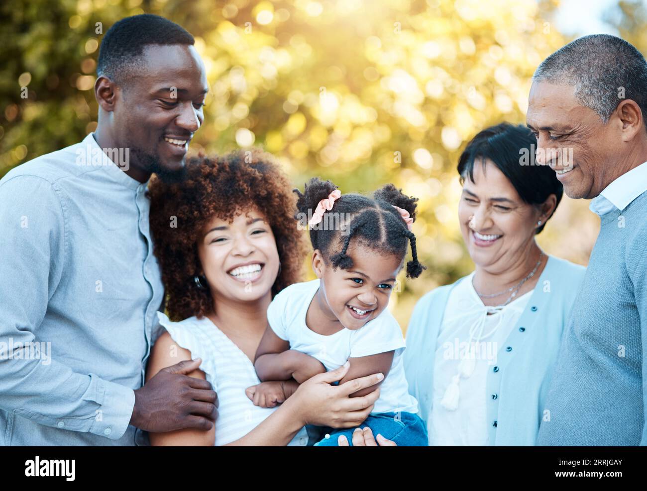 Happy, love and family generations in nature at an outdoor park ...