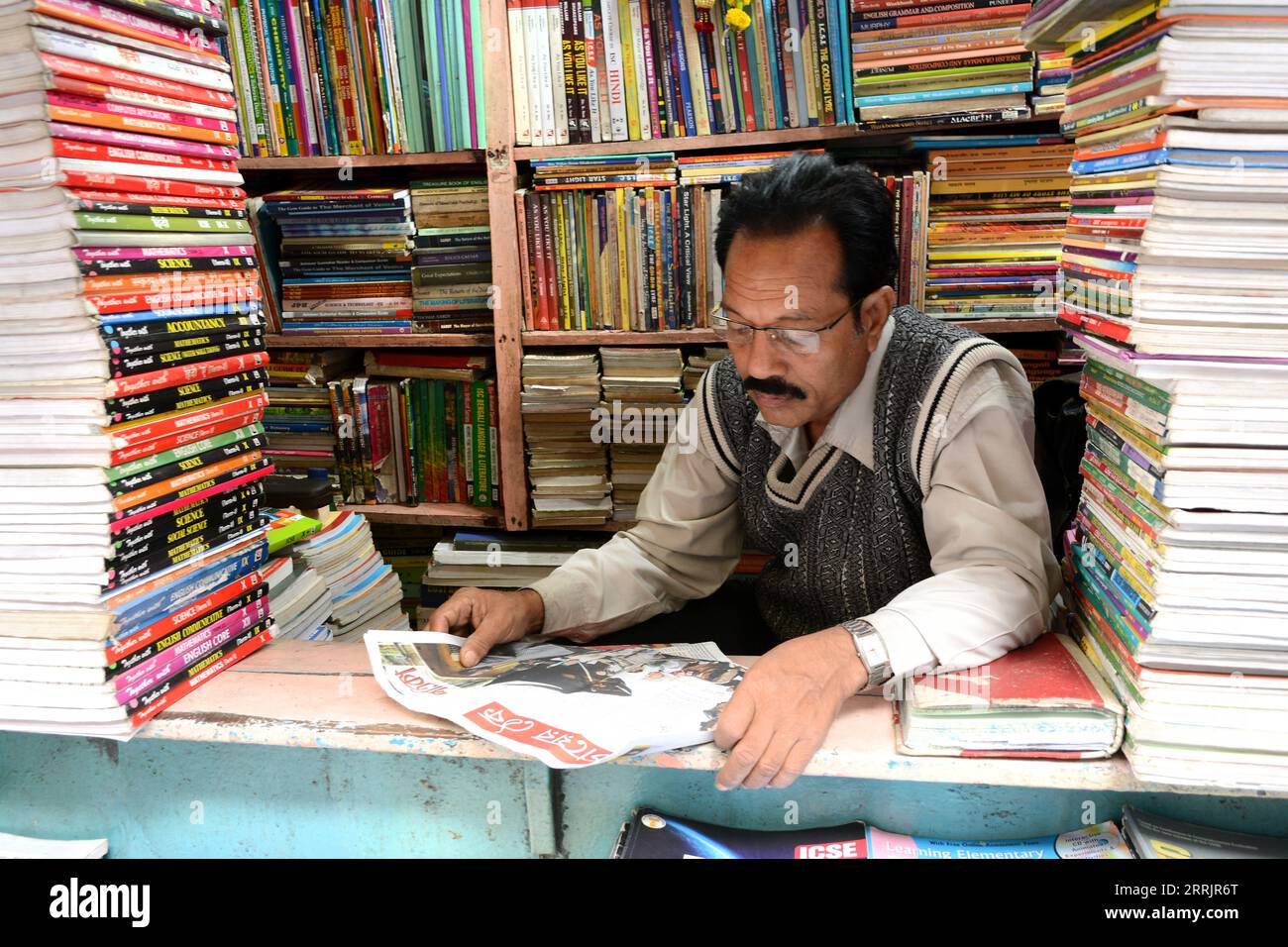 Book seller inside of his book shop in the College Street at Kolkata ...