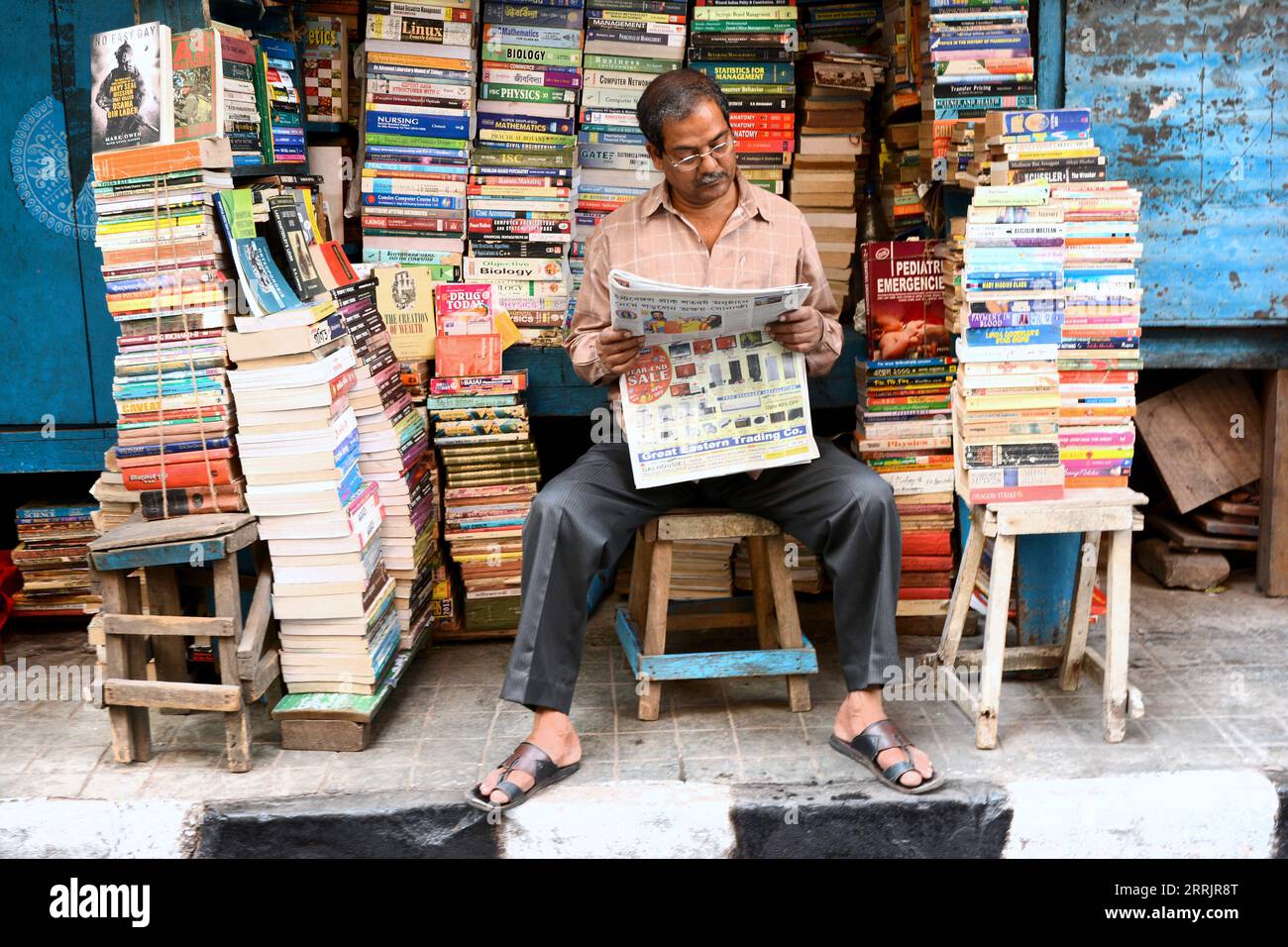 Book seller inside of his book shop in the College Street at Kolkata ...
