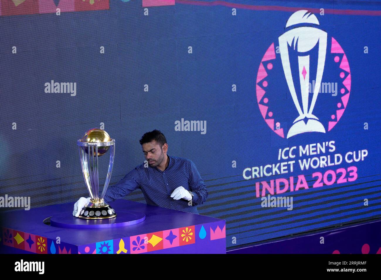 An official wipes the ICC Cricket World Cup trophy before its unveiling ...