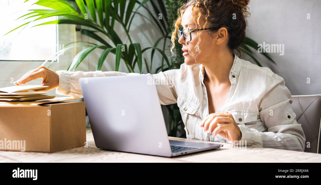 Female employee working with laptop and letters. Workplace. One woman ...