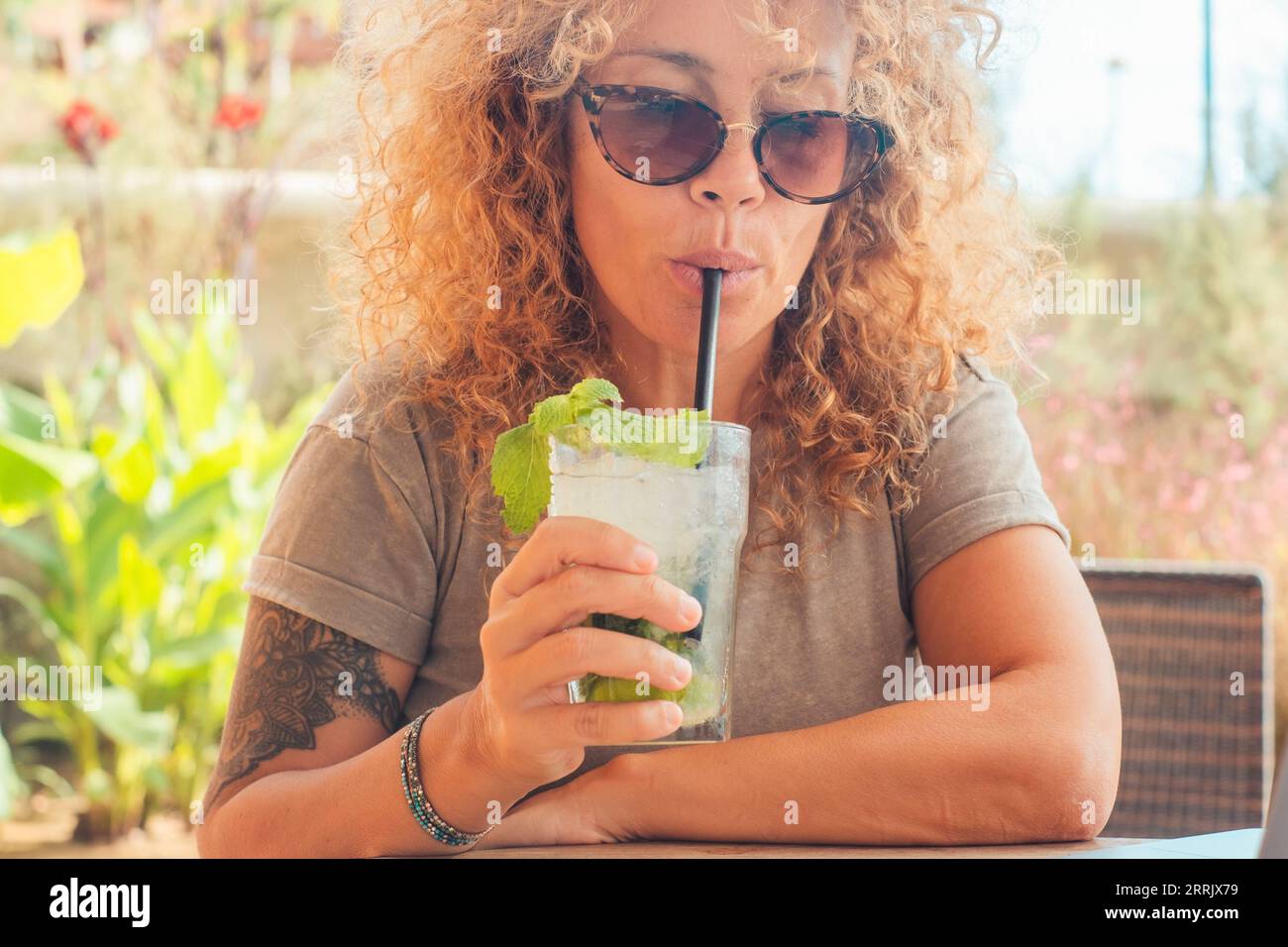 Close up portrait of beauty adult woman drinking mojito fresh cocktail ...