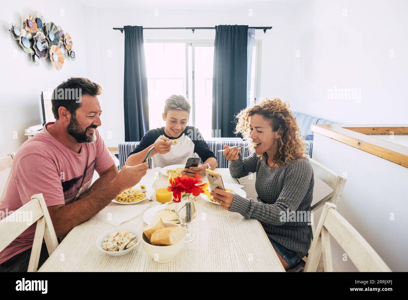 Using phone while eating family hi-res stock photography and images - Alamy