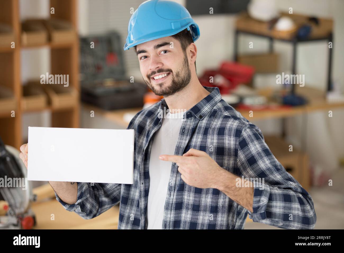 man constructor holding the blank board Stock Photo - Alamy