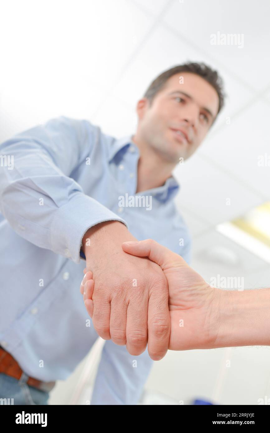 Two business men giving handshake hi-res stock photography and images ...