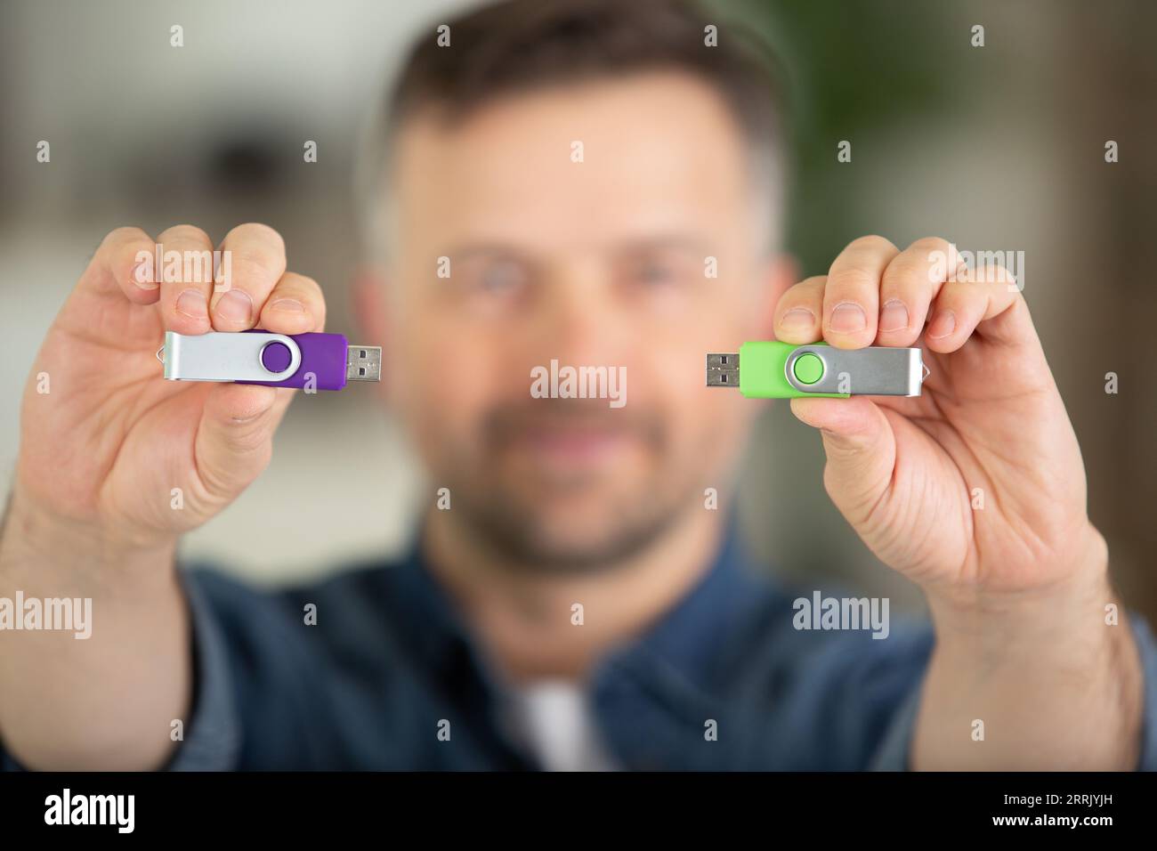 beautiful freelance man holding usb cards Stock Photo - Alamy