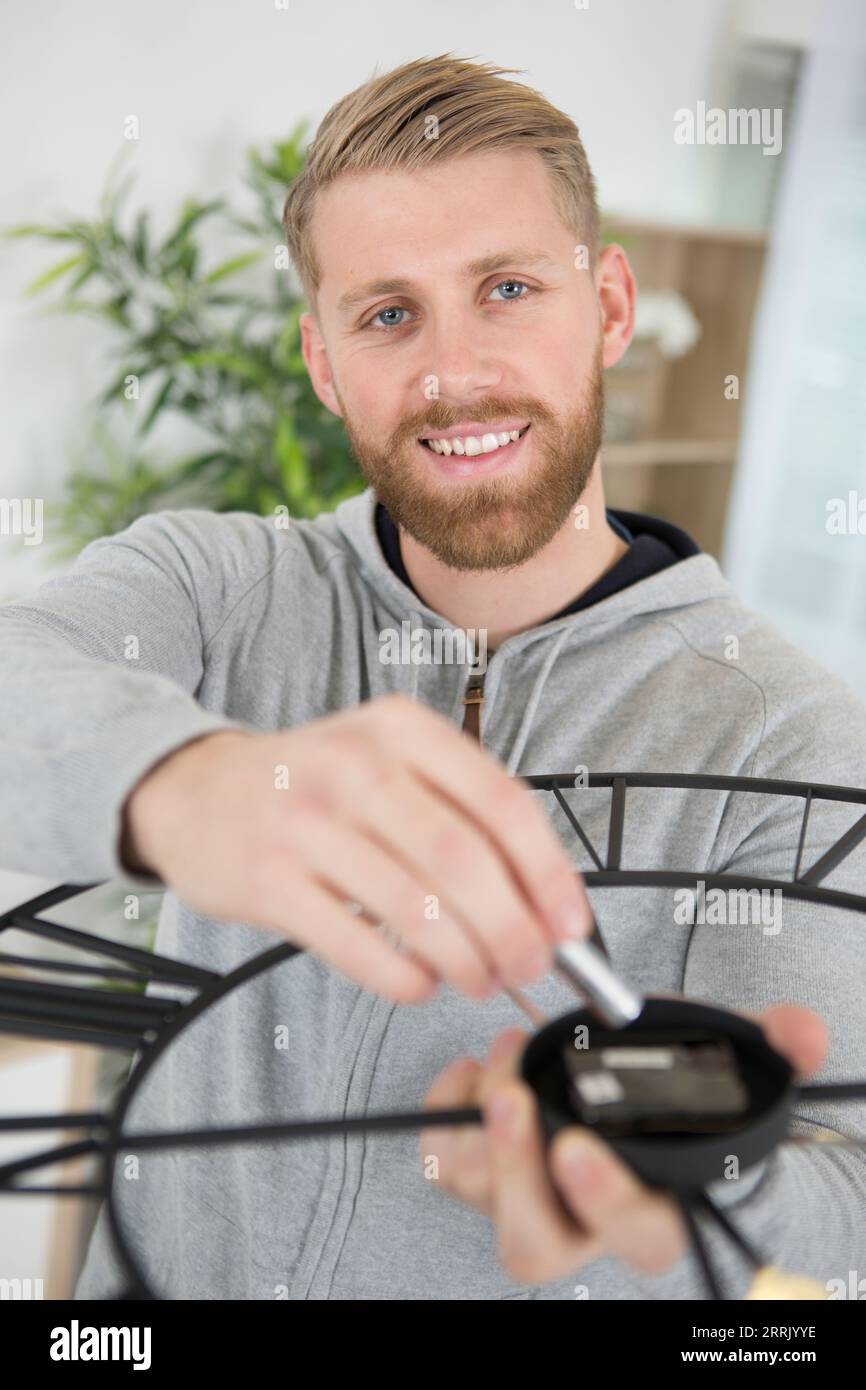 replacing the battery in a quartz wall clock Stock Photo - Alamy
