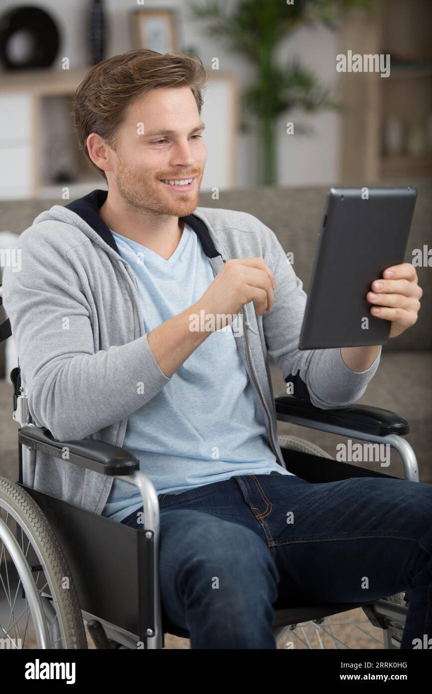 happy disabled person in the wheelchair works in the office Stock Photo ...