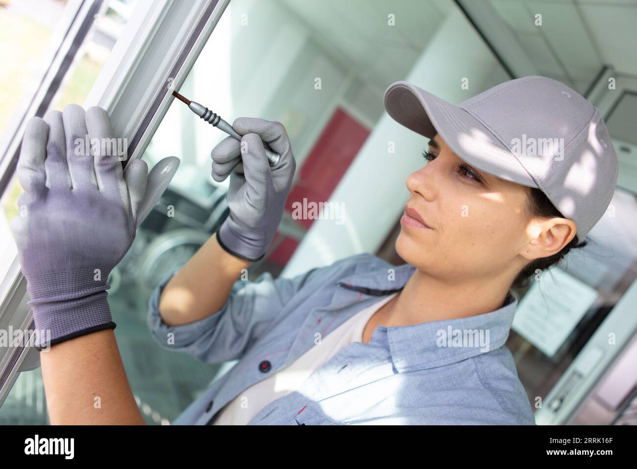 woman installing rubber seal in window Stock Photo - Alamy