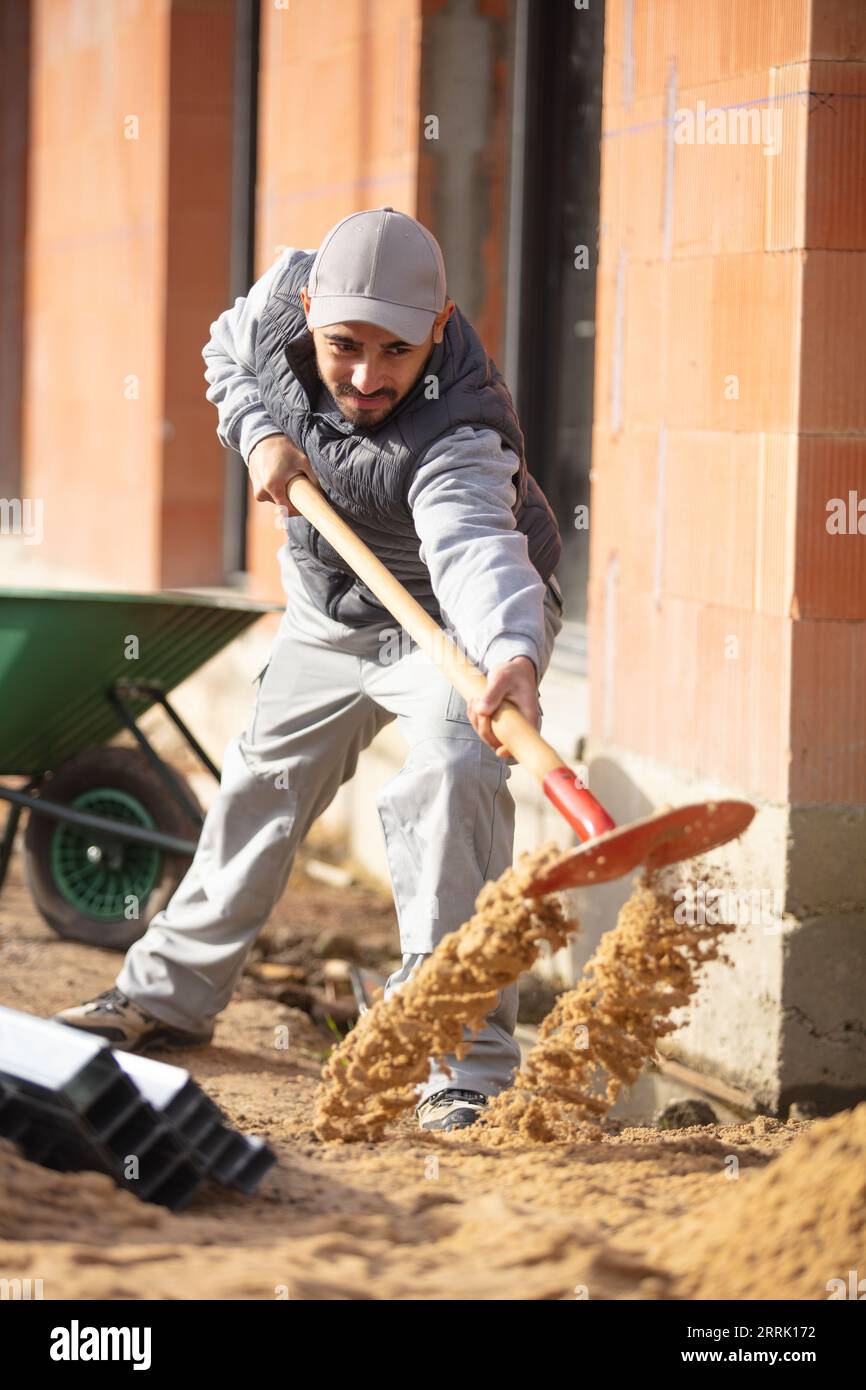 builder works with a shovel Stock Photo - Alamy