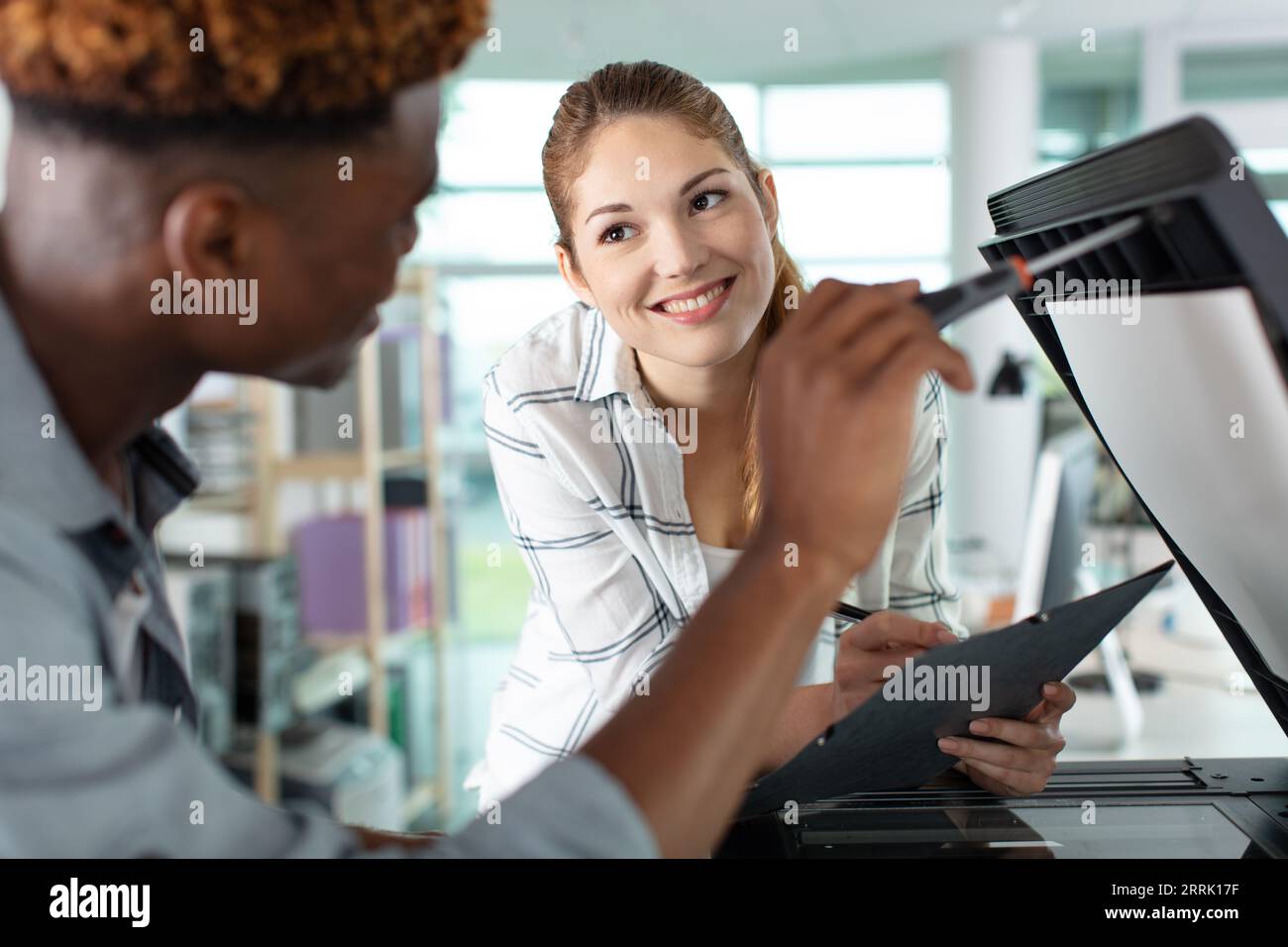 man and woman discussing technical details of printer Stock Photo - Alamy