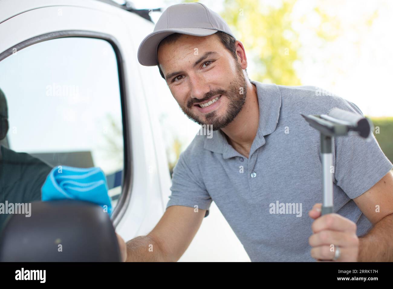 Man worker washing red car hi-res stock photography and images - Alamy