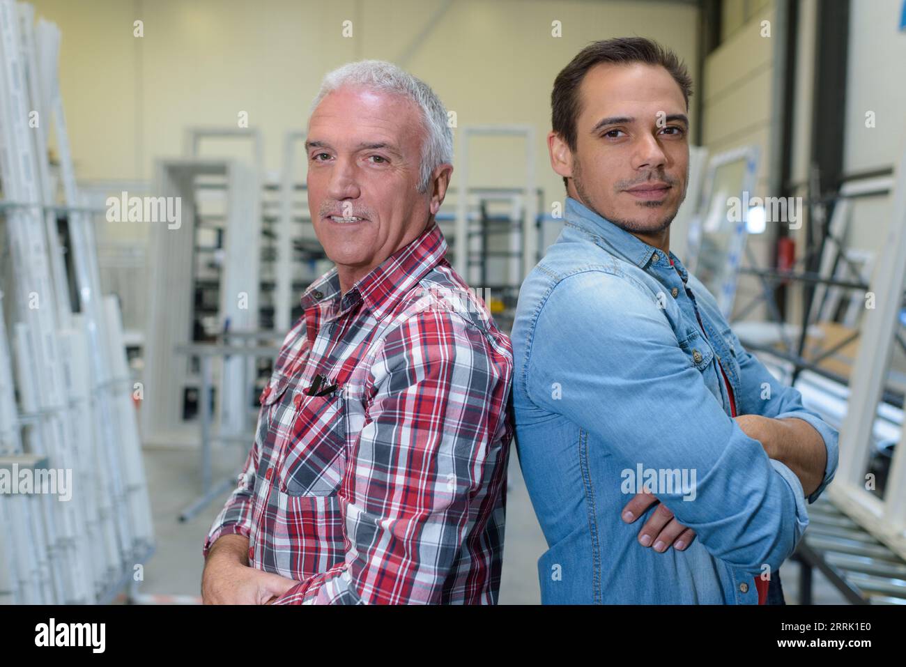 a smiling business people back-to-back Stock Photo - Alamy