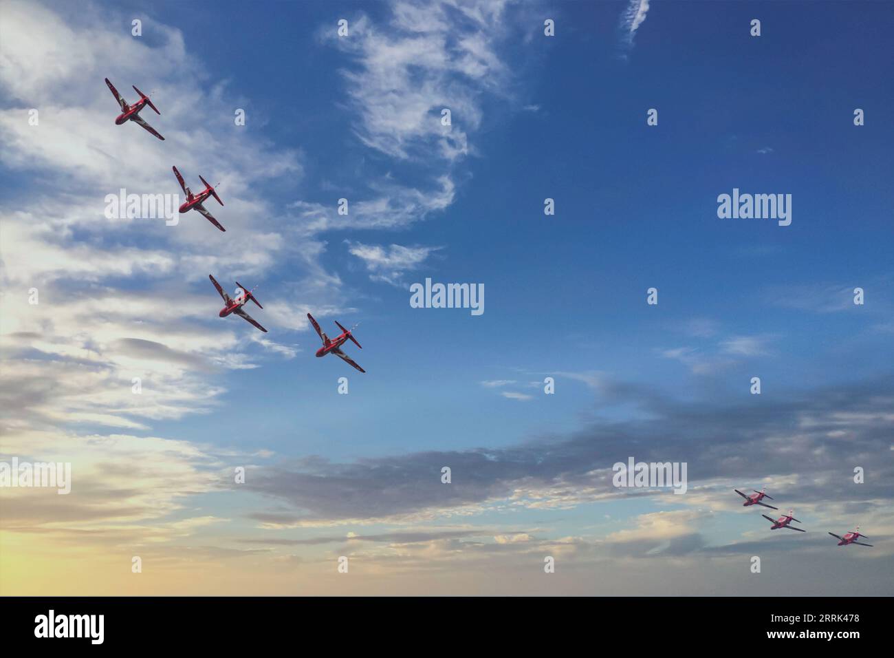 Seven vibrant Red Arrow Hawk Jets soaring into the dazzling evening ...