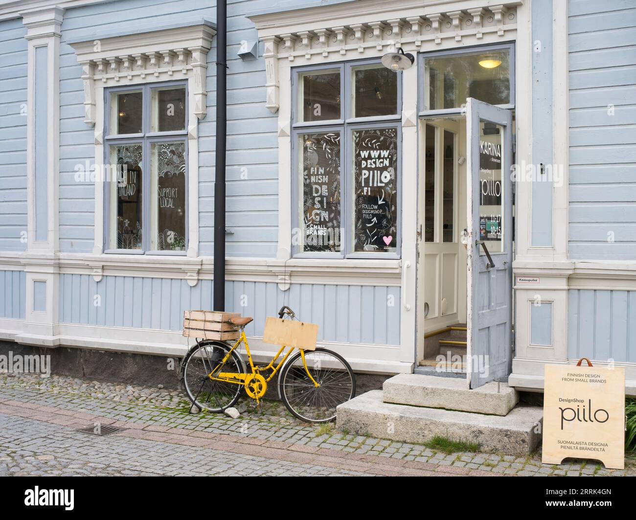 Tallinn street scene, yellow bicycle in front of wooden facade, Estonia ...