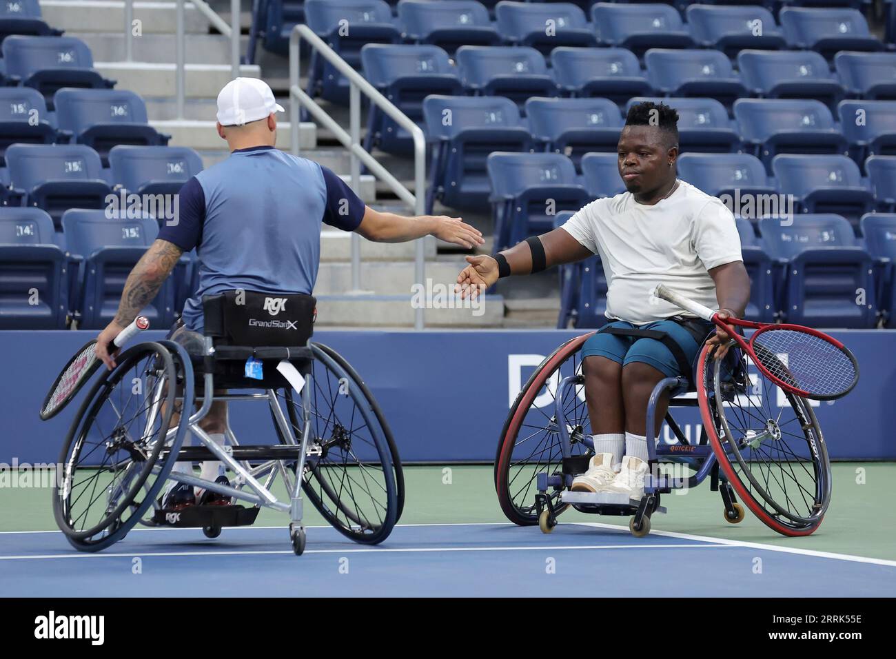 Andy Lapthorne high fives Donald Ramphadi during a wheelchair quad ...