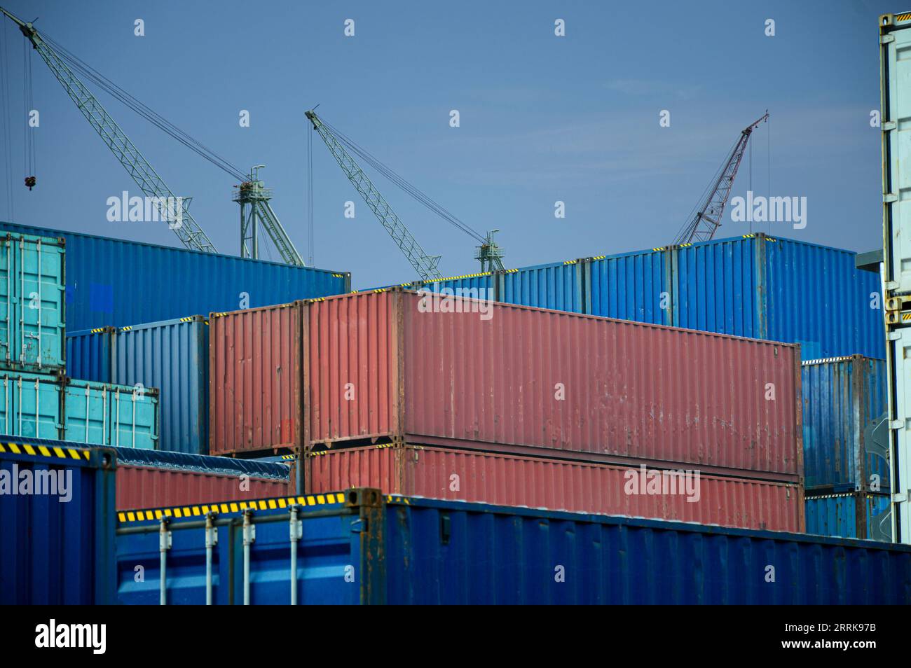 containers awaiting transport and at the back there is a crane to lift ...