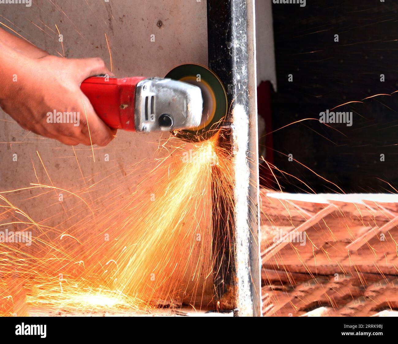 A mechanic was using a grinder, and many sparks appeared Stock Photo ...