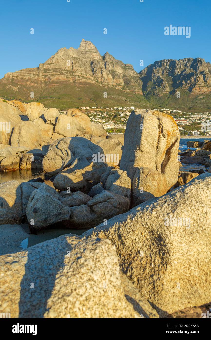 South Africa, Cape Town, Camps Bay, rocks in water, evening light, 12 ...
