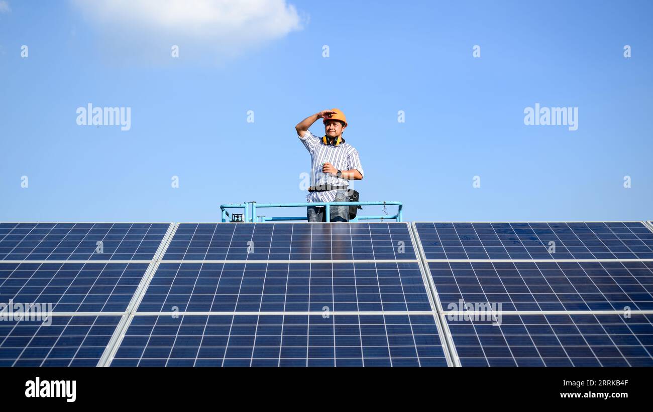 Professional technician worker installing solar panels at solar cell ...