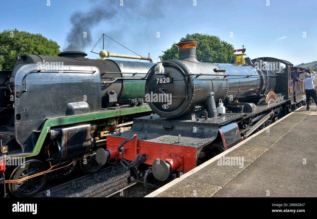 Two steam trains at the GWR preserved train station platform Winchcombe Gloucestershire England ...