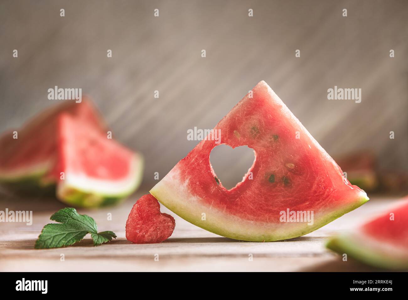 A cut piece of watermelon with a heart-shaped hole. concept Summer, joy ...