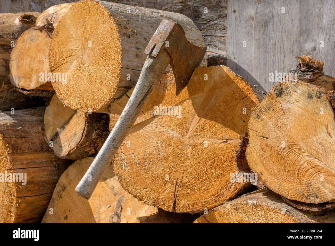 Firewood with axe Stock Photo - Alamy