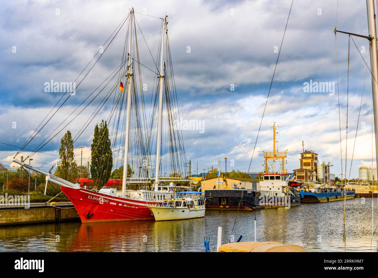 Inland harbor with red tall ship and typical harbor buildings Stock ...