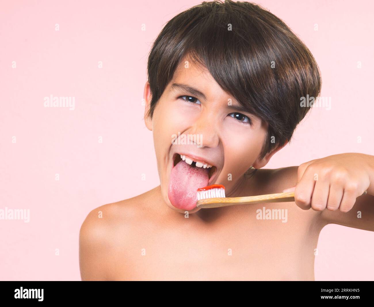 Child brushing his teeth and sticking out his tongue Stock Photo - Alamy