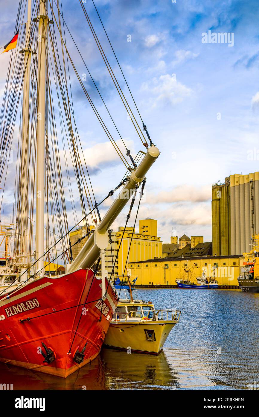 red tall ship in the historic harbor of Brake, in the background ...