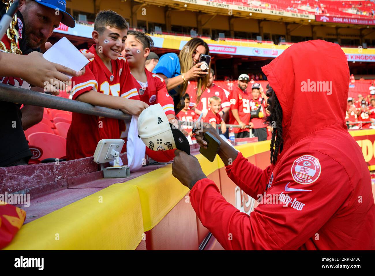 Kansas City Chiefs linebacker Cam Jones, right, signs autographs for ...