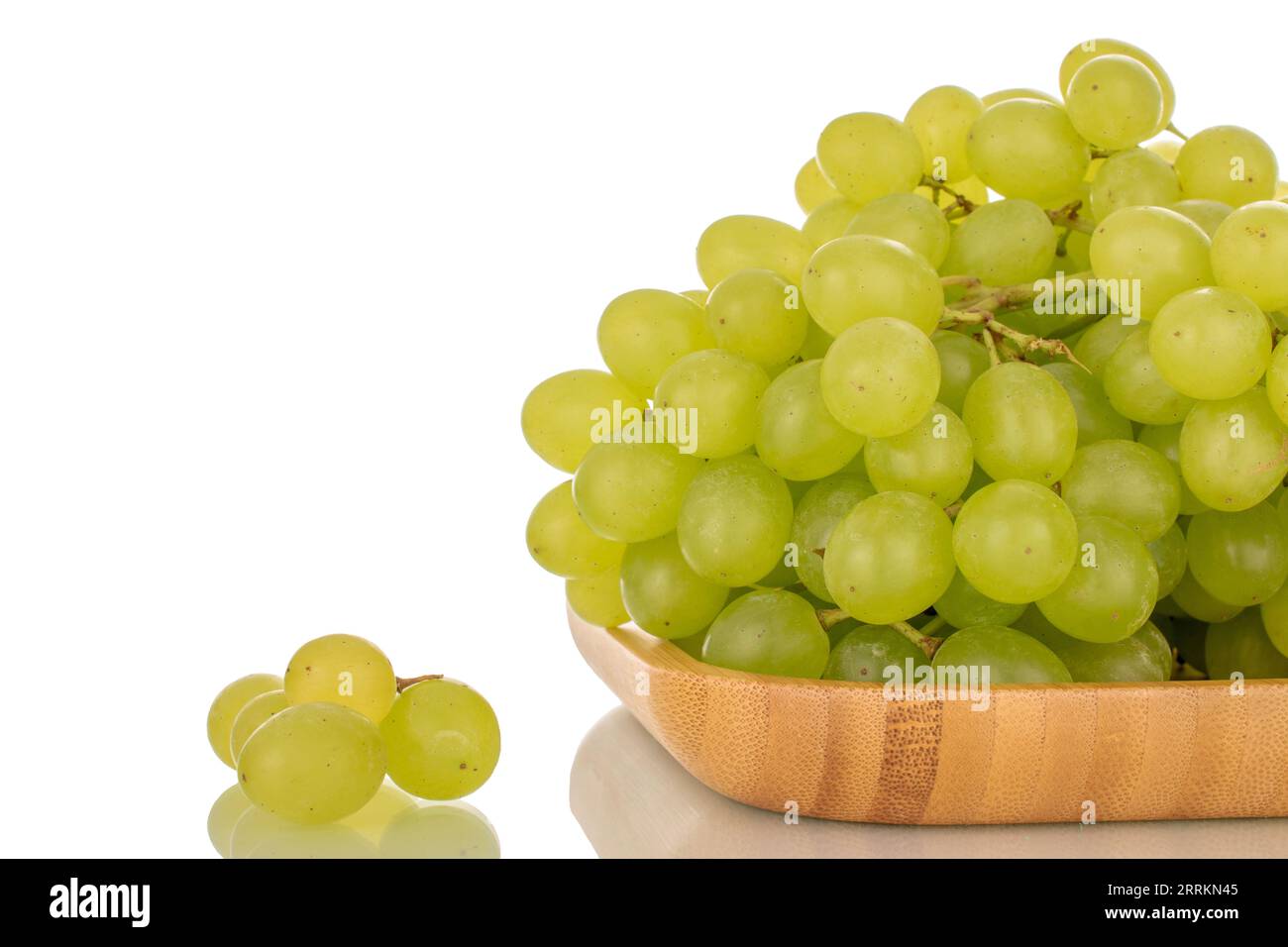 Sweet juicy seedless grapes on bamboo tray, macro, isolated on white ...