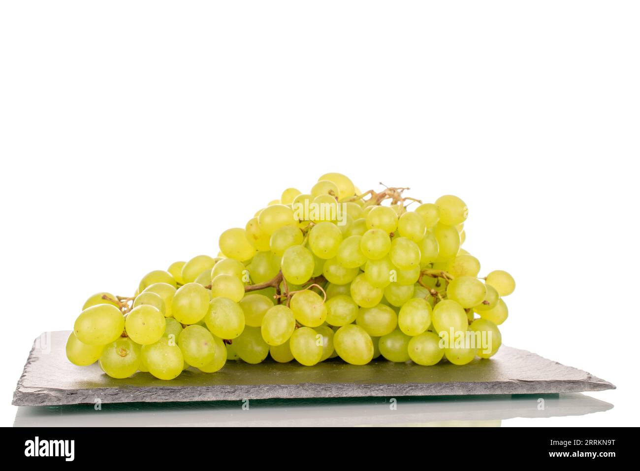 Sweet juicy seedless grapes on a stone tray, macro, isolated on white ...