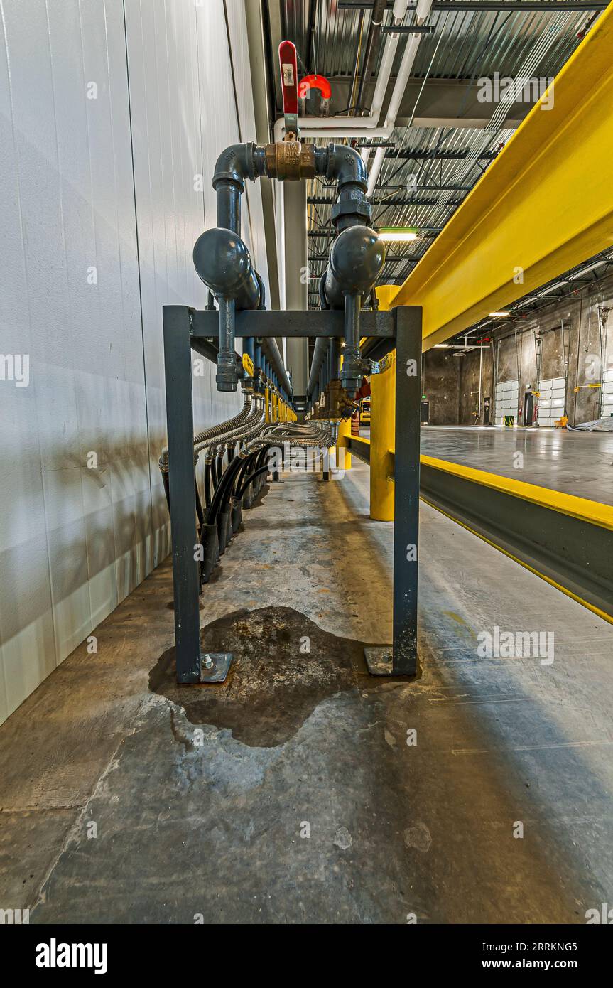 Piping for fluids to warm concrete floor in cold-storage warehouse ...