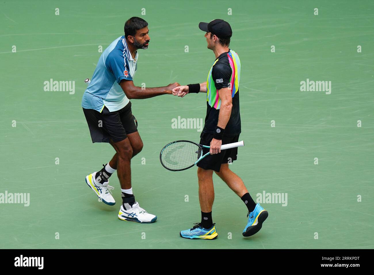 Rohan Bopana, of India, left, bumps fists with doubles partner Matthew ...