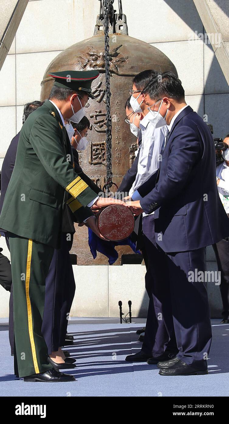 220918 -- SHENYANG, Sept. 18, 2022 -- People strike a huge bell during ...