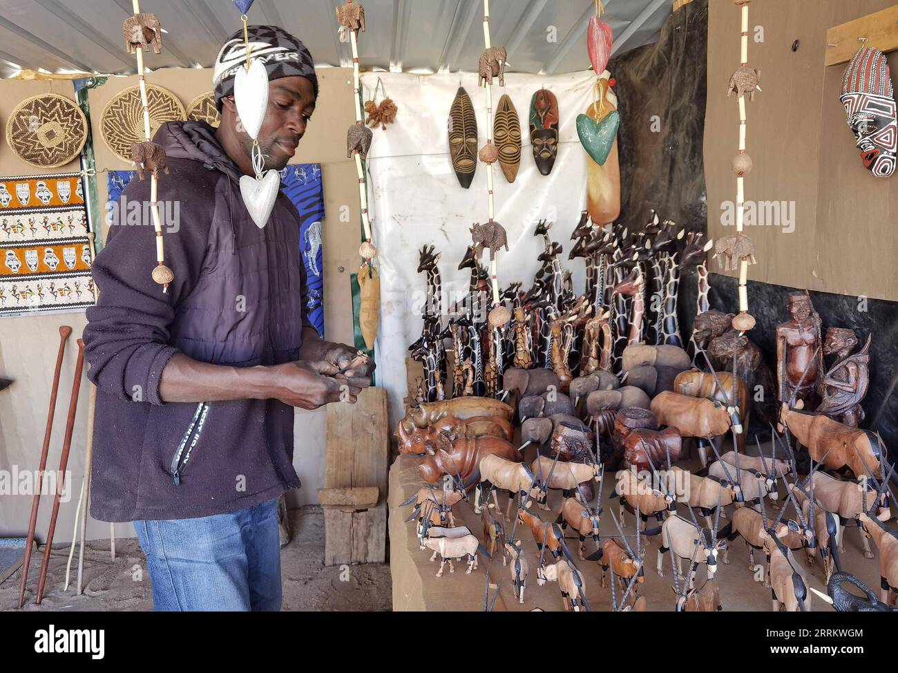 220920 -- OKAHANDJA NAMIBIA, Sept. 20, 2022 -- An artist arranges ...
