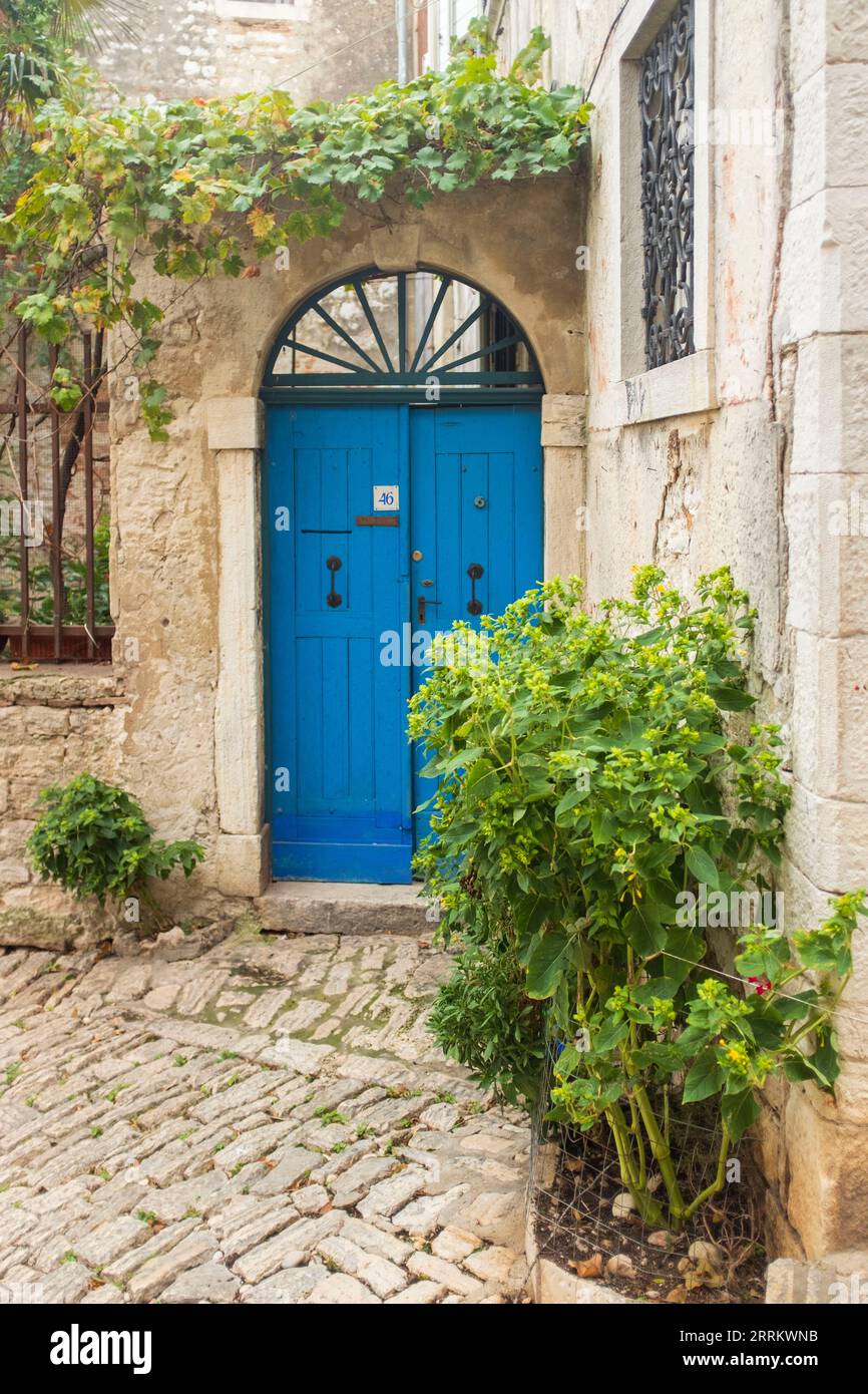 Entrance with a bright blue door Stock Photo - Alamy