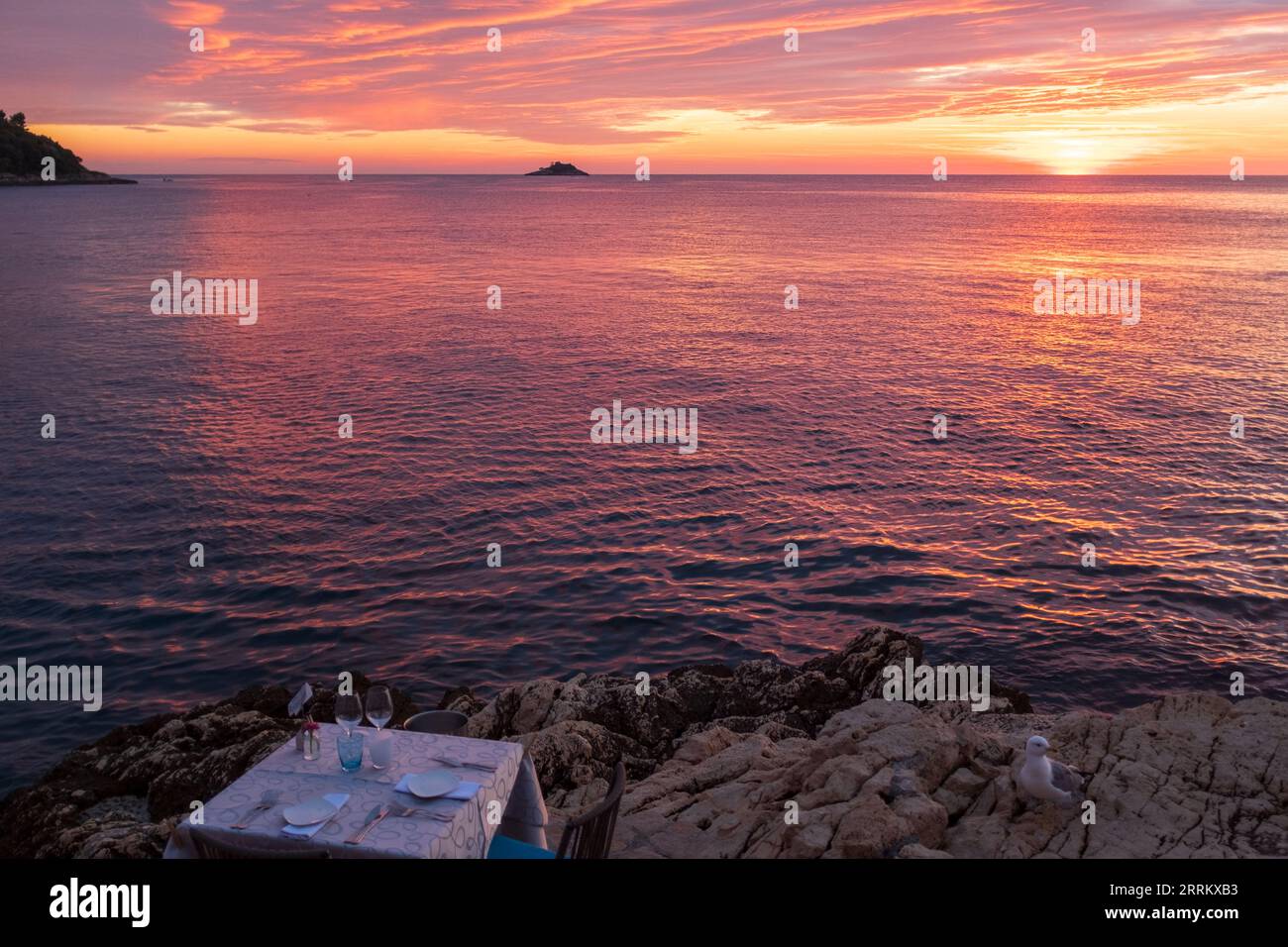 set table with seaview at sunset Stock Photo - Alamy