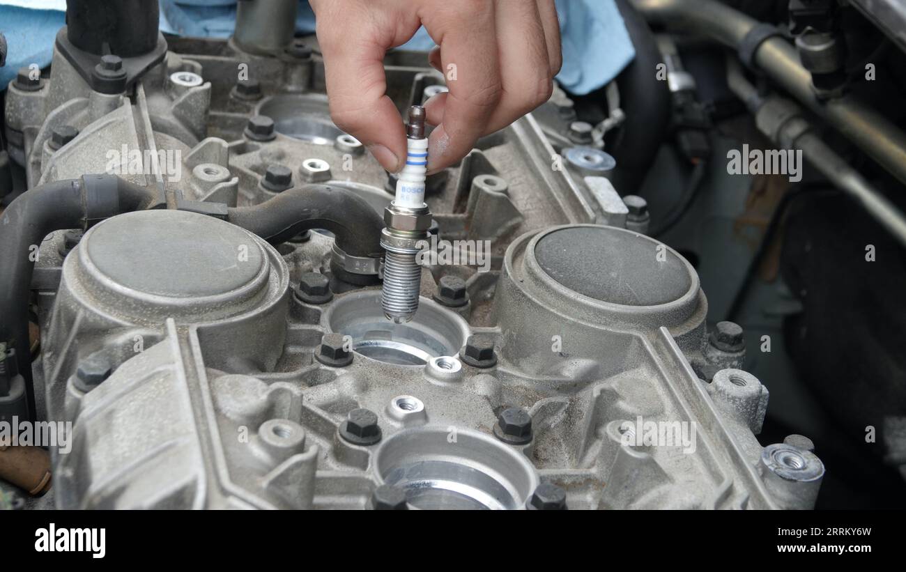 Vista, CA USA - September 3, 2023: Close up of hand inserting new spark ... Vista, CA USA - September 3, 2023: Close up of hand inserting new spark ...