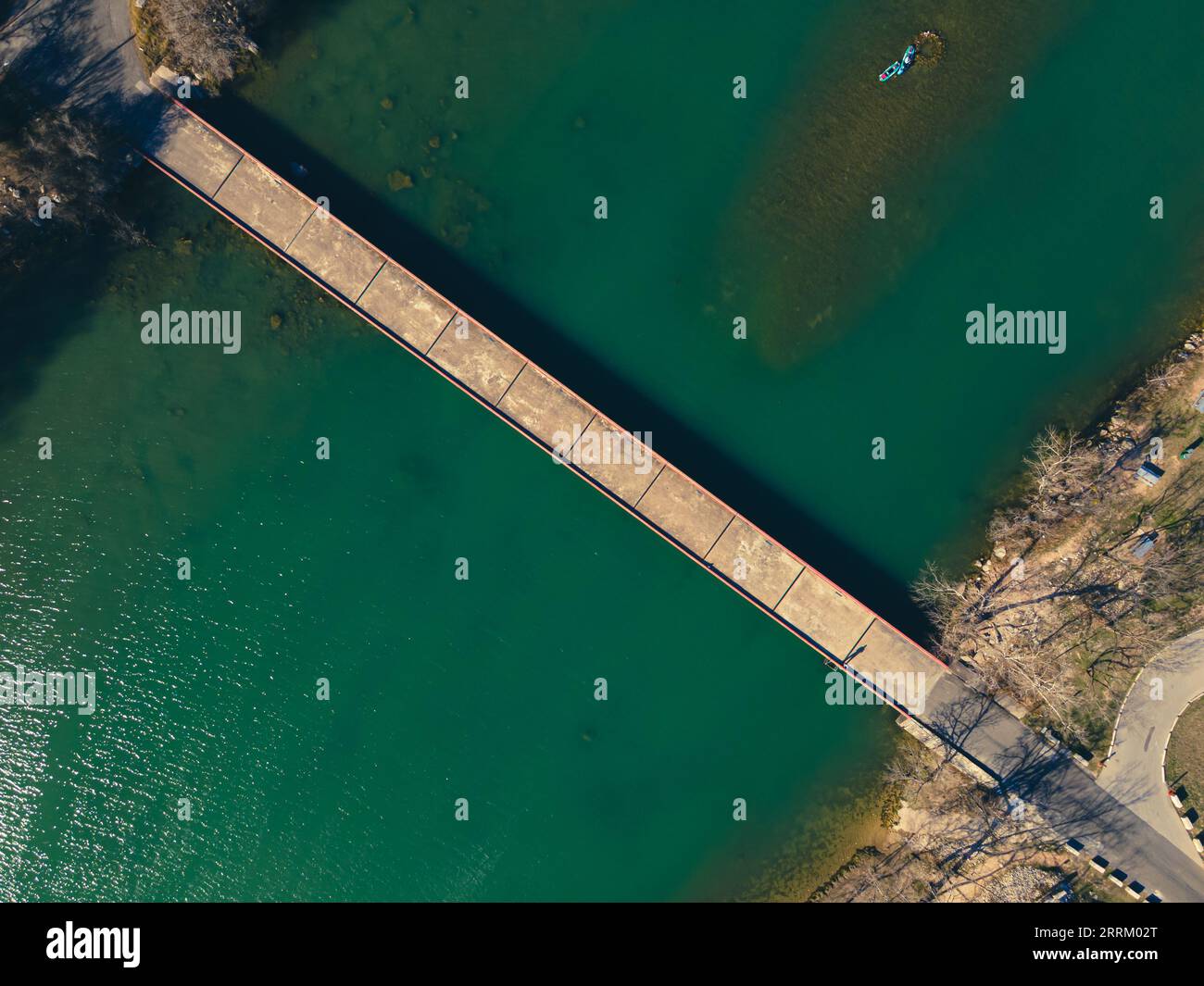 an aerial view of Mansfield Dam with crystal-clear blue water on a ...