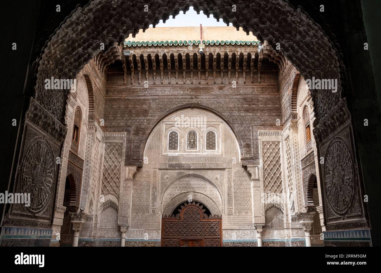 Rich decorated facade in the courtyard of the Medersa Attarine in Fes ...