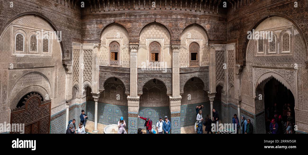 Rich decorated facade in the courtyard of the Medersa Attarine in Fes ...