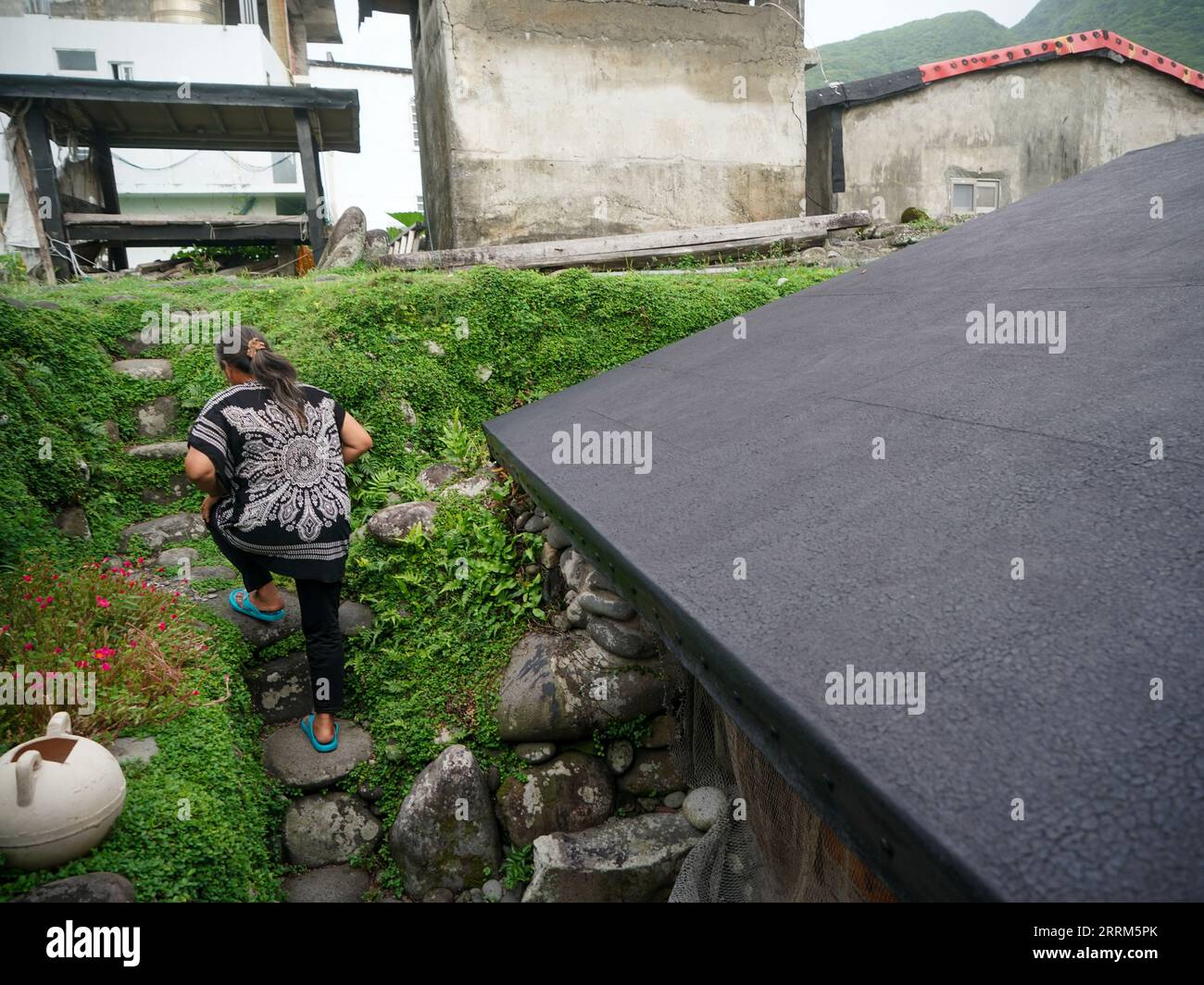 Ayoy, a mid-aged aboriginal from Tao community, is climbing up to the ...