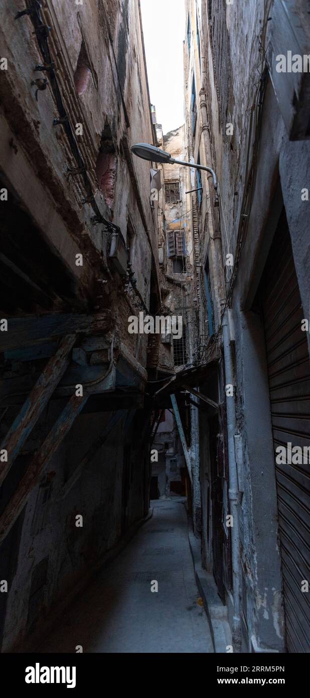 Very narrow alley with high residential buildings built close together ...