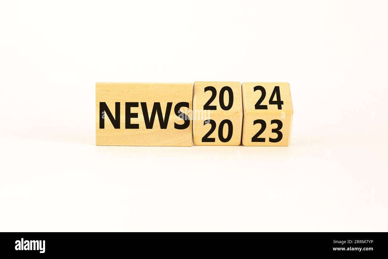 2024 News new year symbol. Businessman turns a wooden cube and changes ...