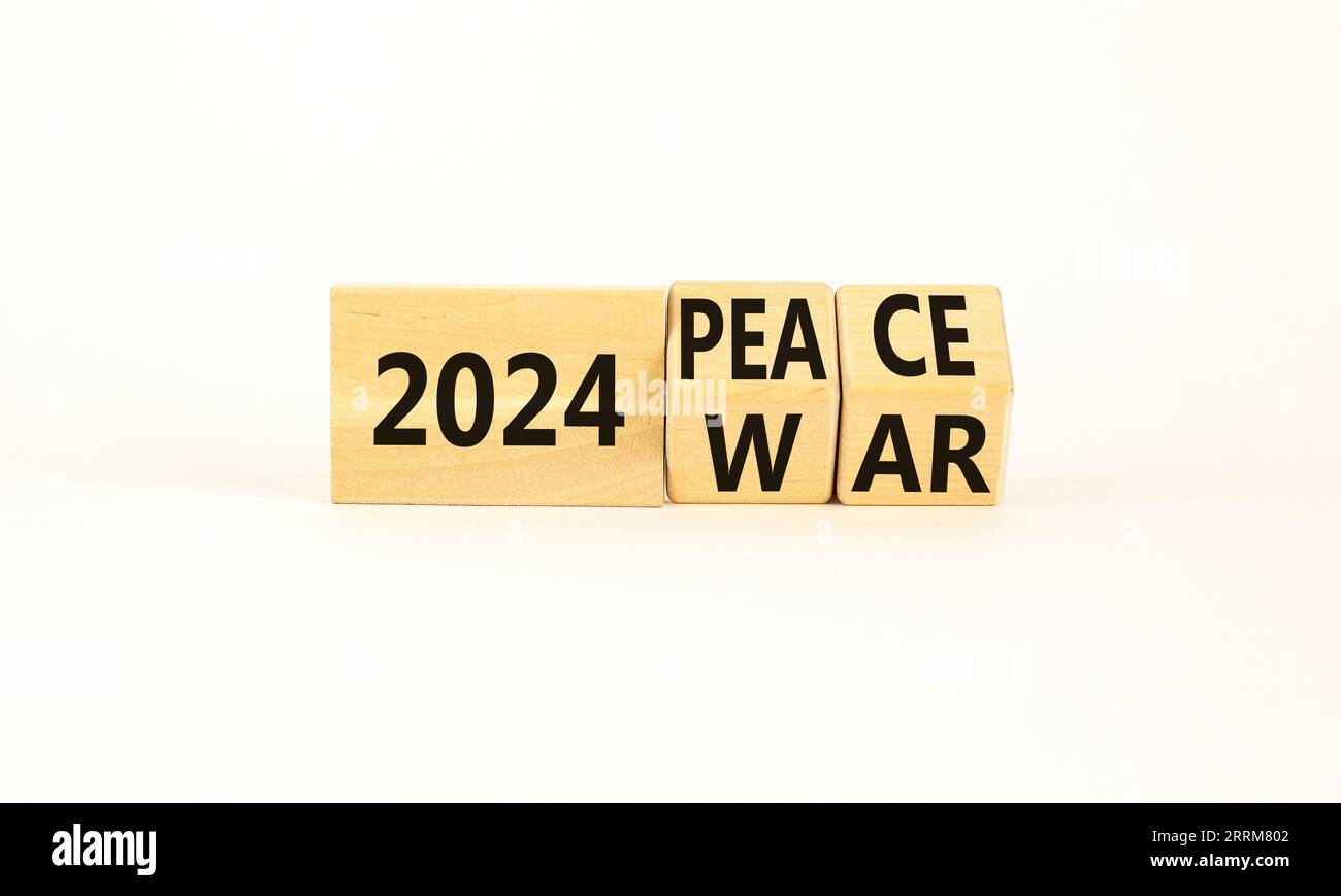 2024 war or peace symbol. Businessman turns a wooden cube and changes ...
